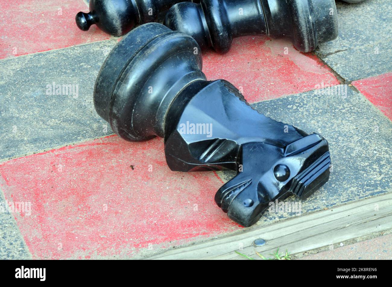 Fallen Black Knight on Outdoor Mega Chess Board Stock Photo - Alamy