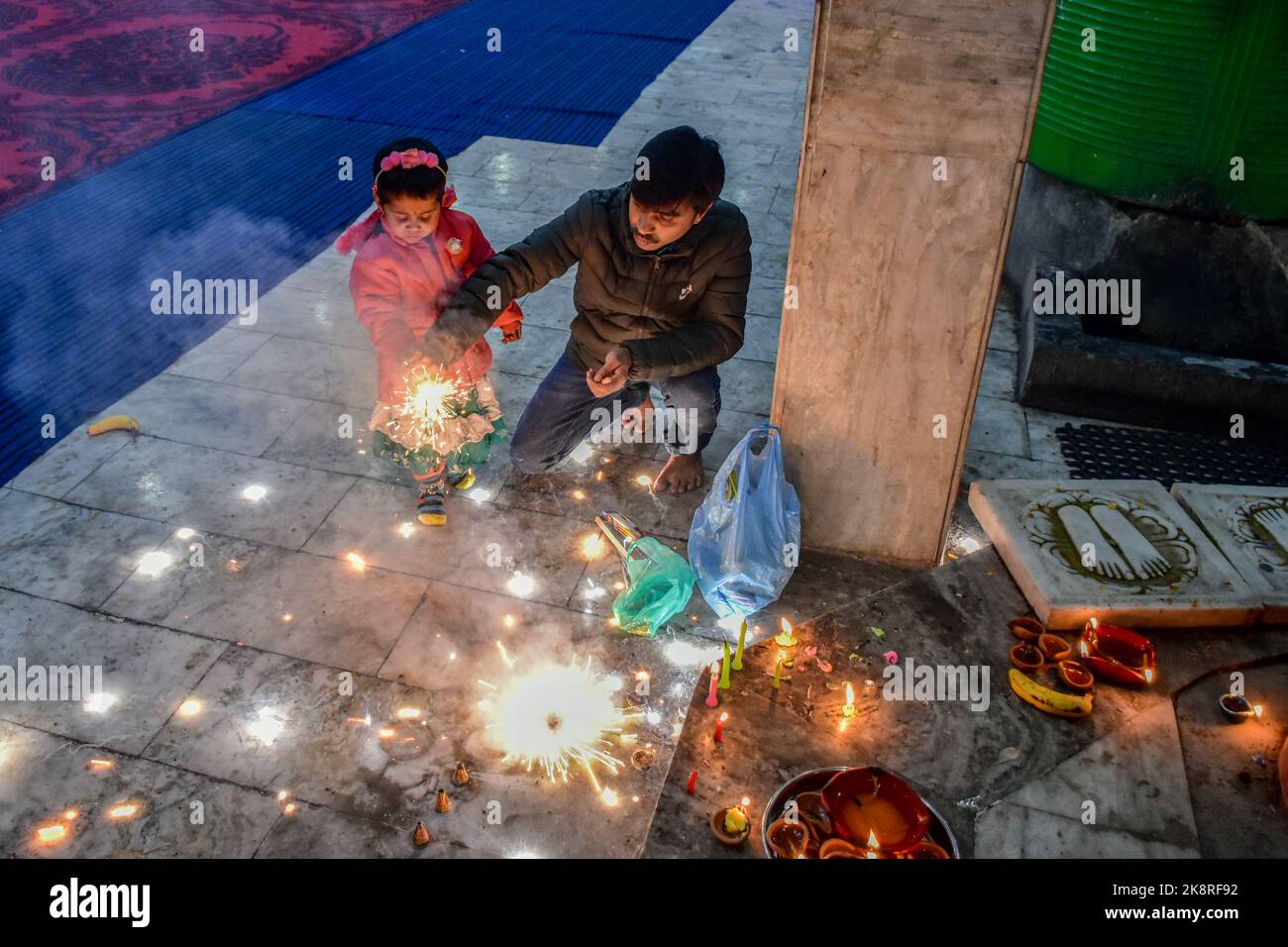 Srinagar, India. 24th Oct, 2022. Hindu devotees light up fire crackers ...