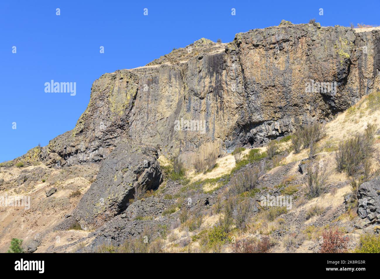 Basalt cliff face rises above a dry slope in Central Washington Stock Photo - Alamy
