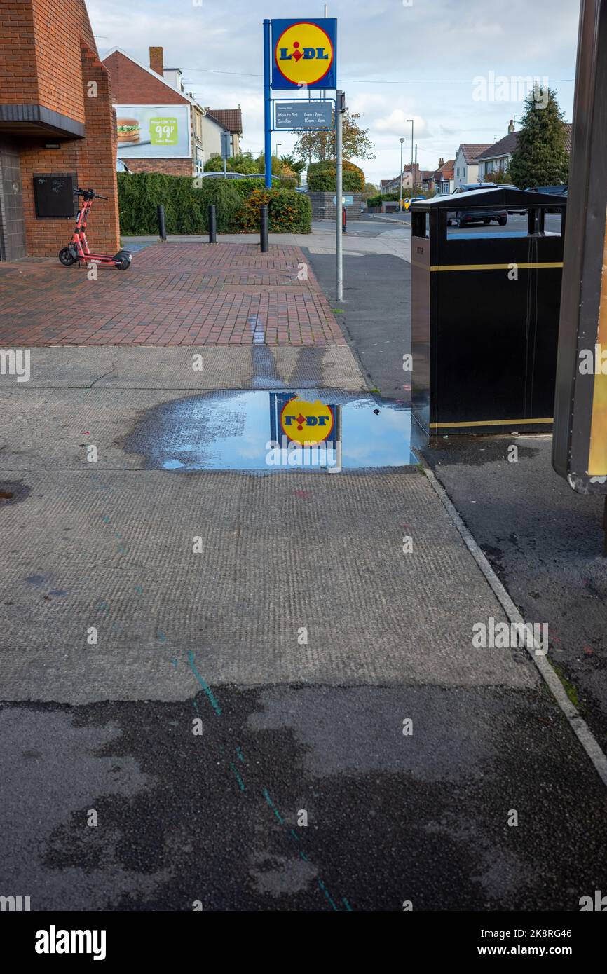 Lidl store sign reflecting in a puddle of water (Oct22 Stock Photo - Alamy