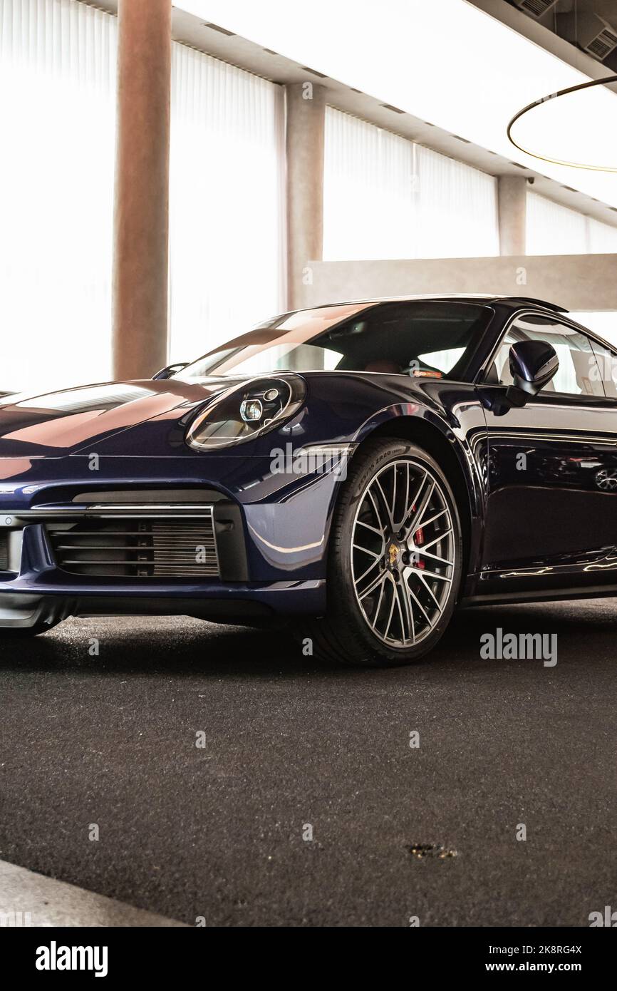 A vertical shot of a black Porsche 911 Turbo 992 Gen Stock Photo - Alamy