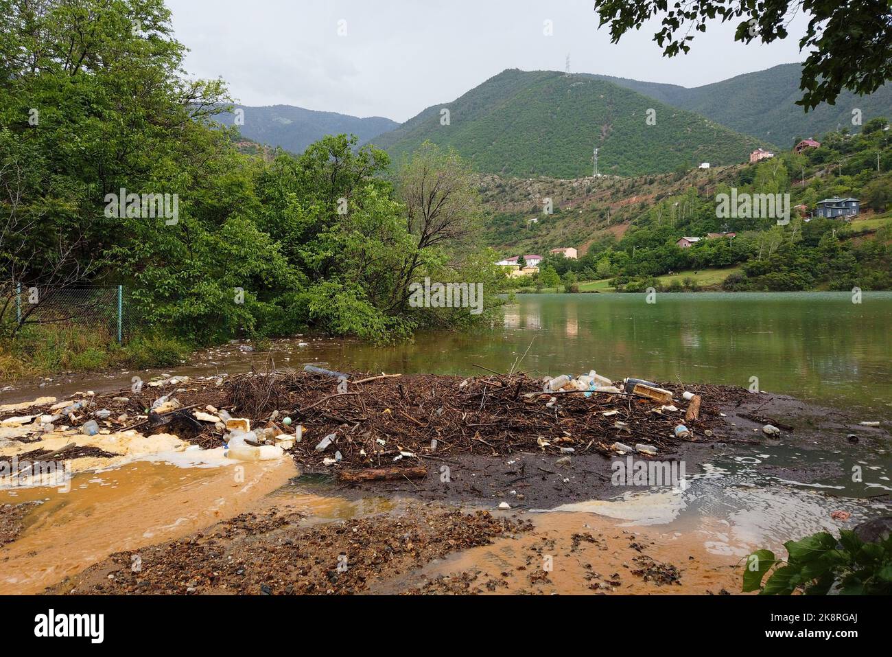 Garbage and sediment carried by the stream feeding the dam lake in ...