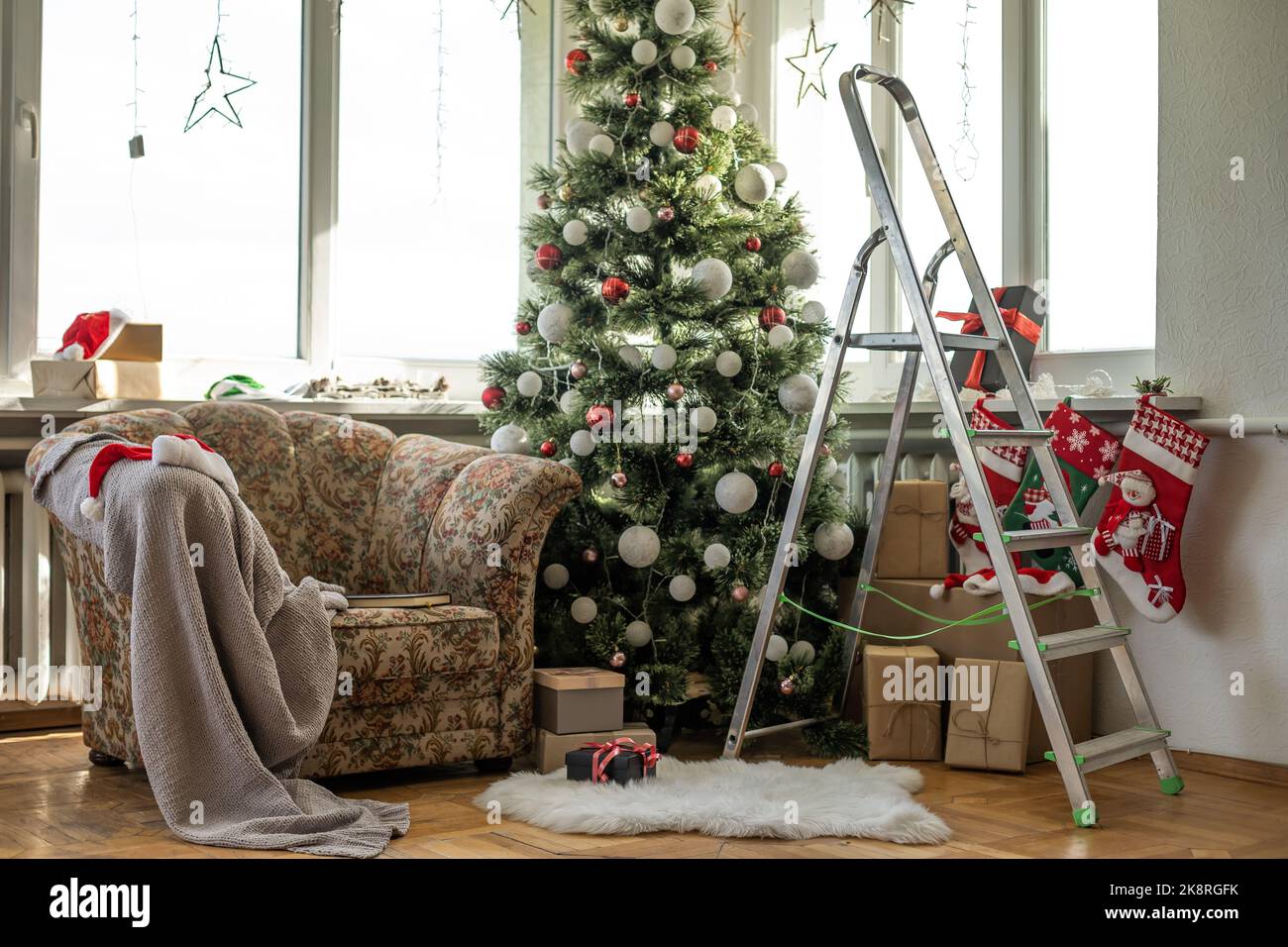 high angle view of christmas tree with messy boxes on floor of new ...