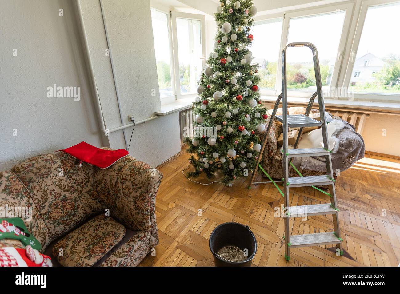high angle view of christmas tree with messy boxes on floor of new ...