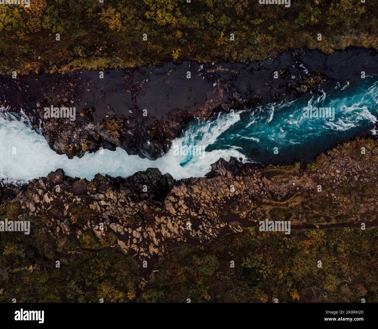 An aerial shot of a waterfall between cliffs Stock Photo - Alamy