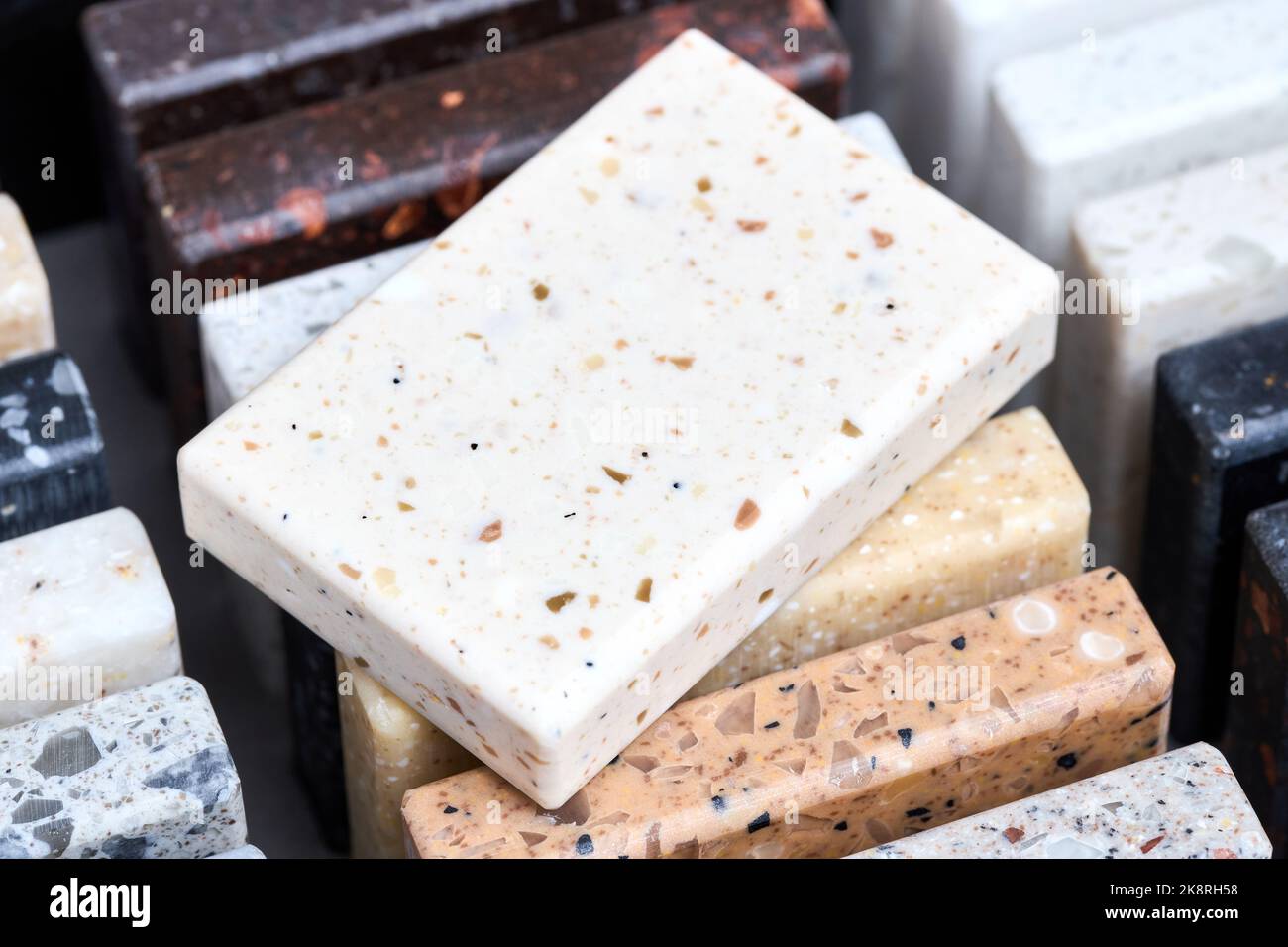 Porcelain one stoneware square sample laid on kitchen countertop ...