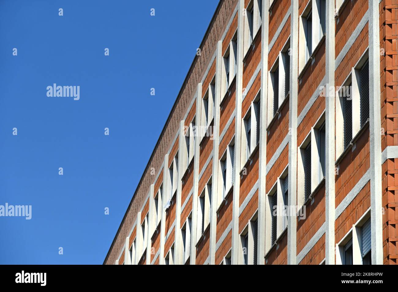 A perspective view from below of the building facade under a blue sky ...