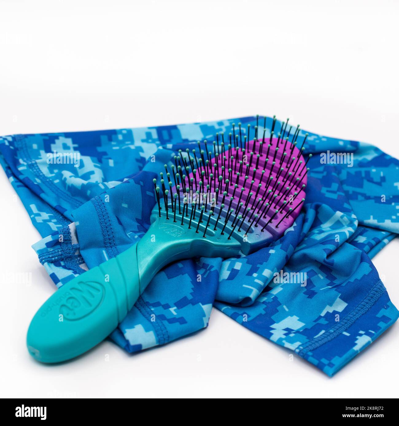 A closeup of a hair brush on a white table Stock Photo - Alamy