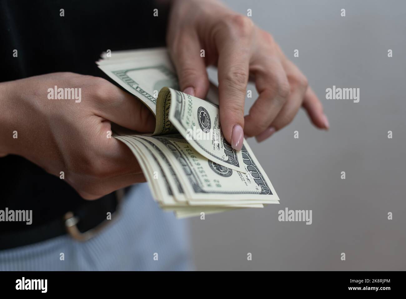 woman counting money isolated on a white background Stock Photo - Alamy