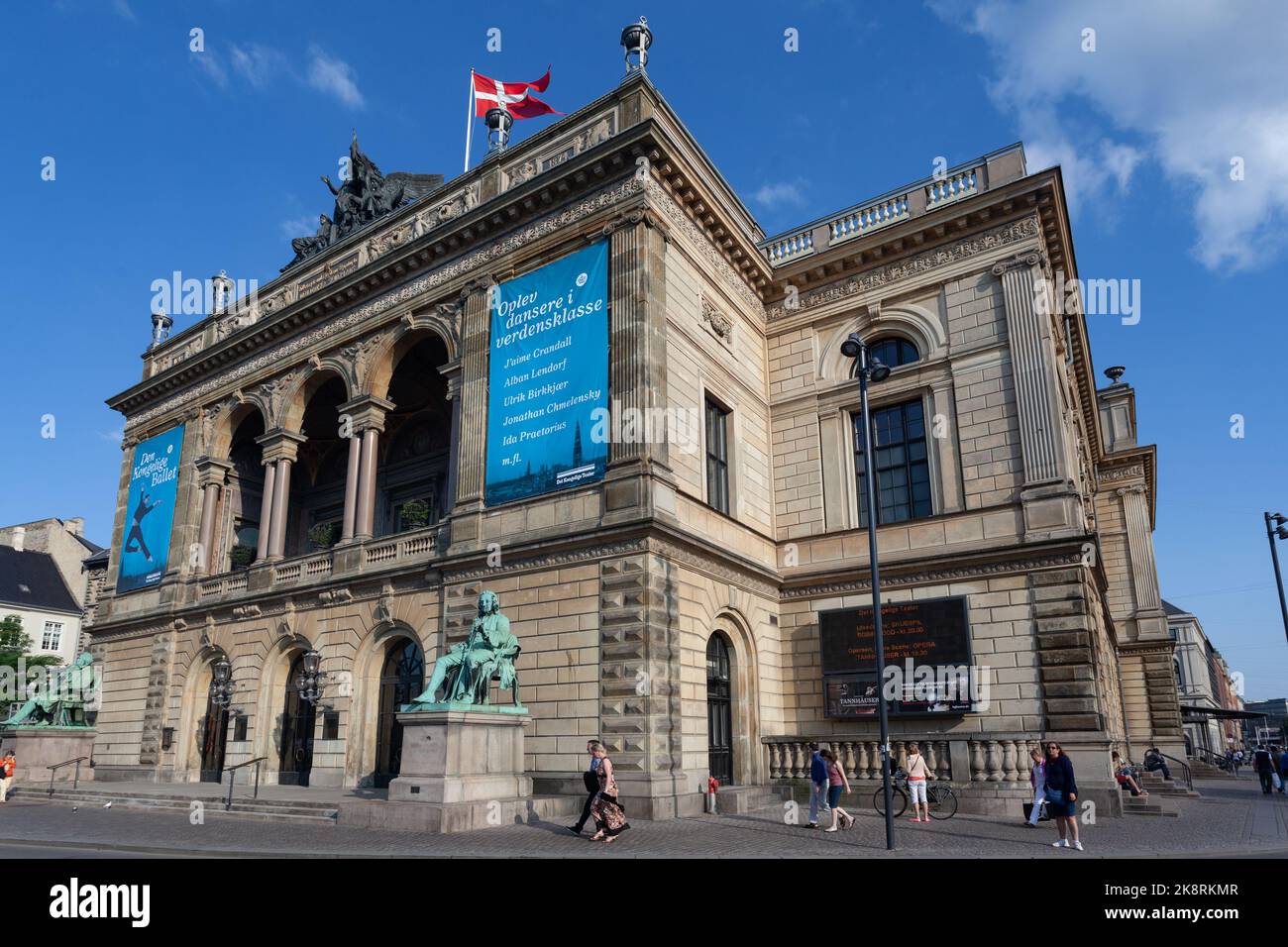 The Royal Theatre facade in Copenhagen, Denmark against a clear blue ...