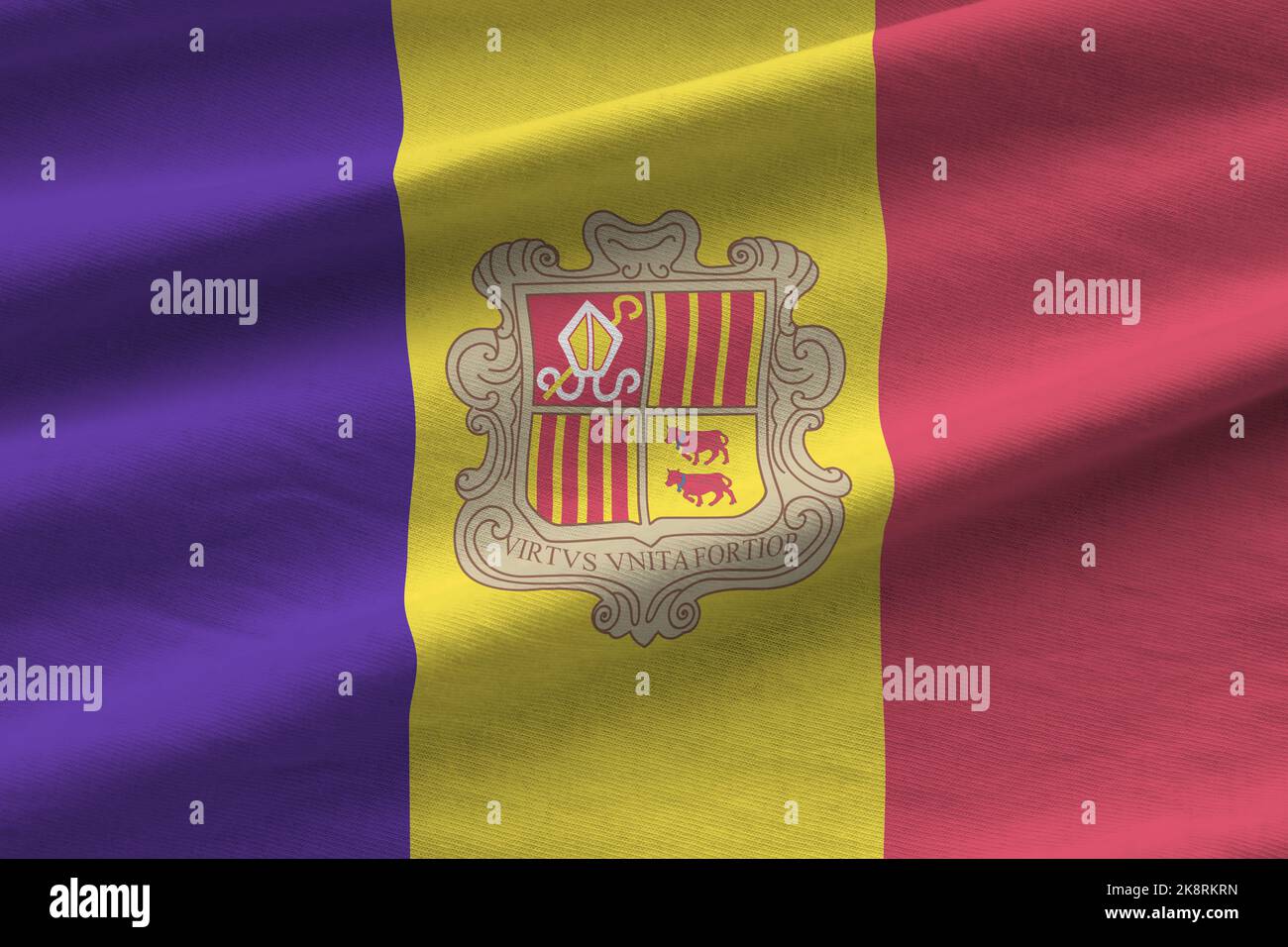 Andorra flag with big folds waving close up under the studio light ...