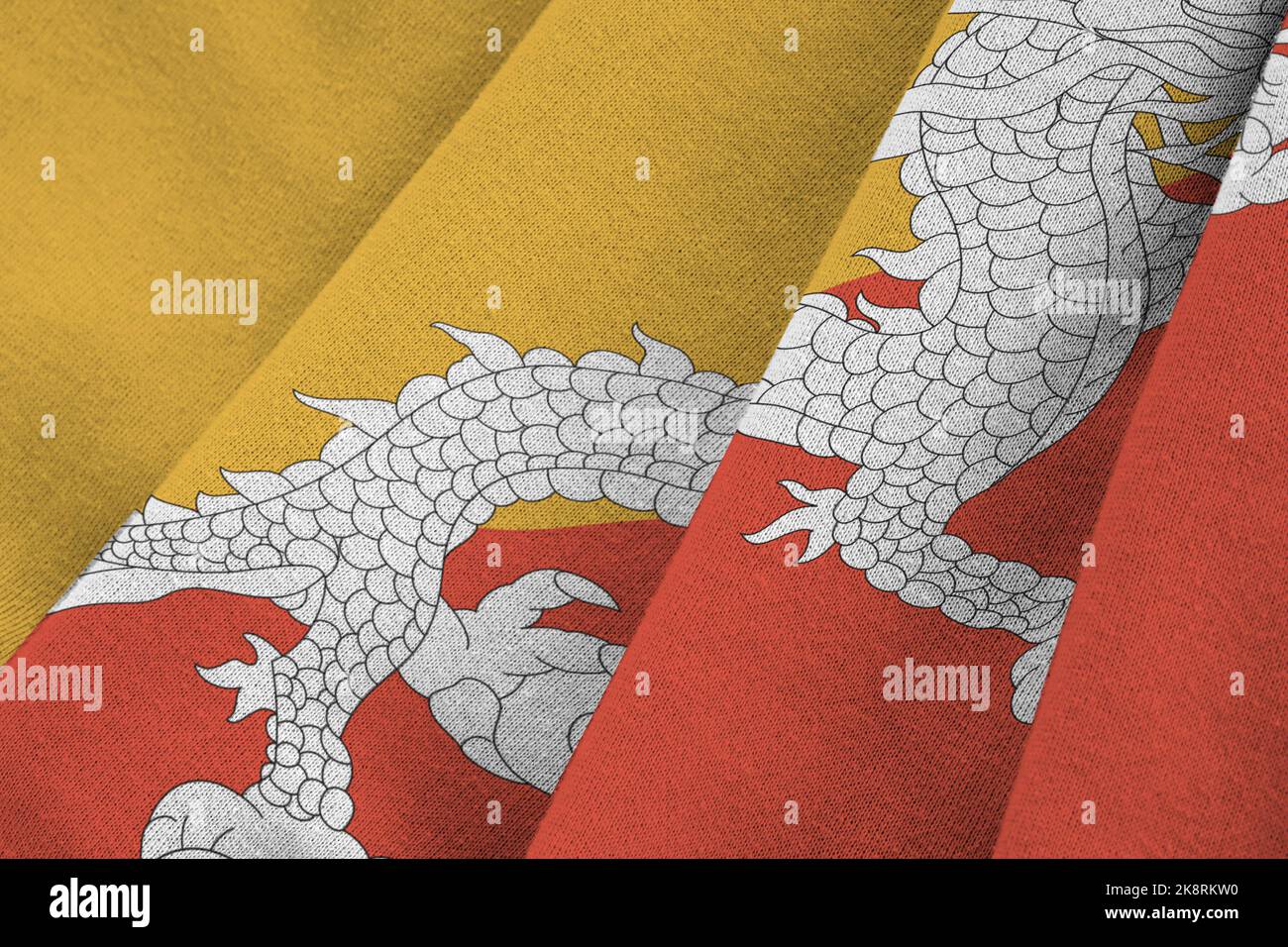 Bhutan flag with big folds waving close up under the studio light ...