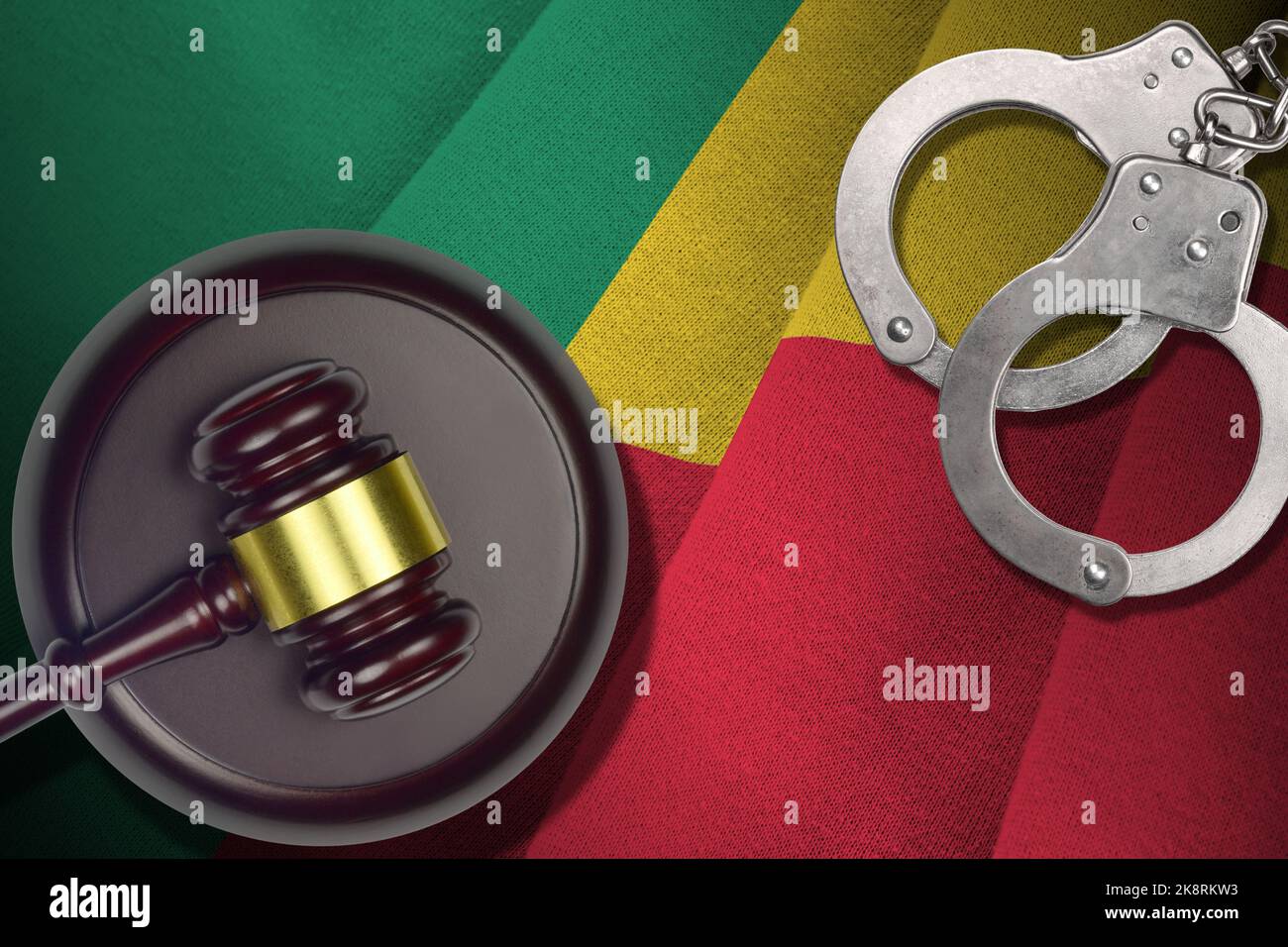 Benin flag with judge mallet and handcuffs in dark room. Concept of ...