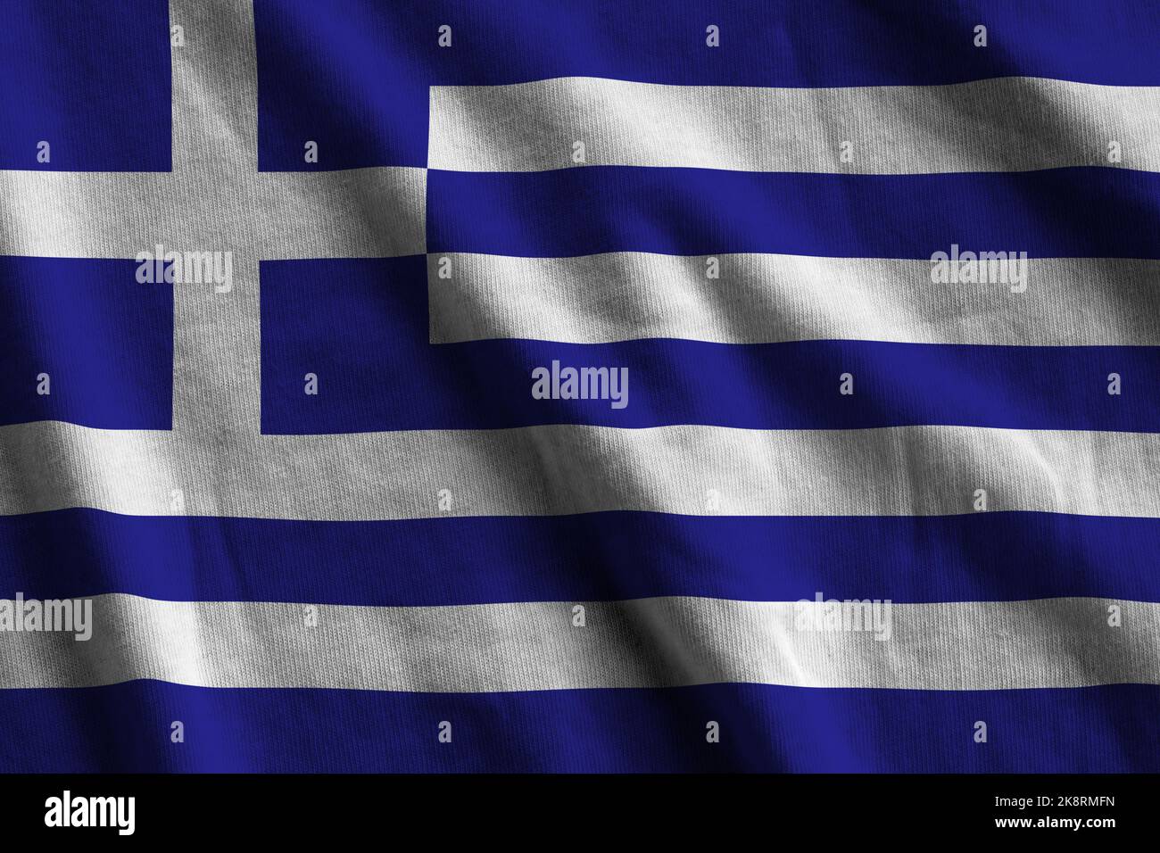 Greece flag with big folds waving close up under the studio light ...