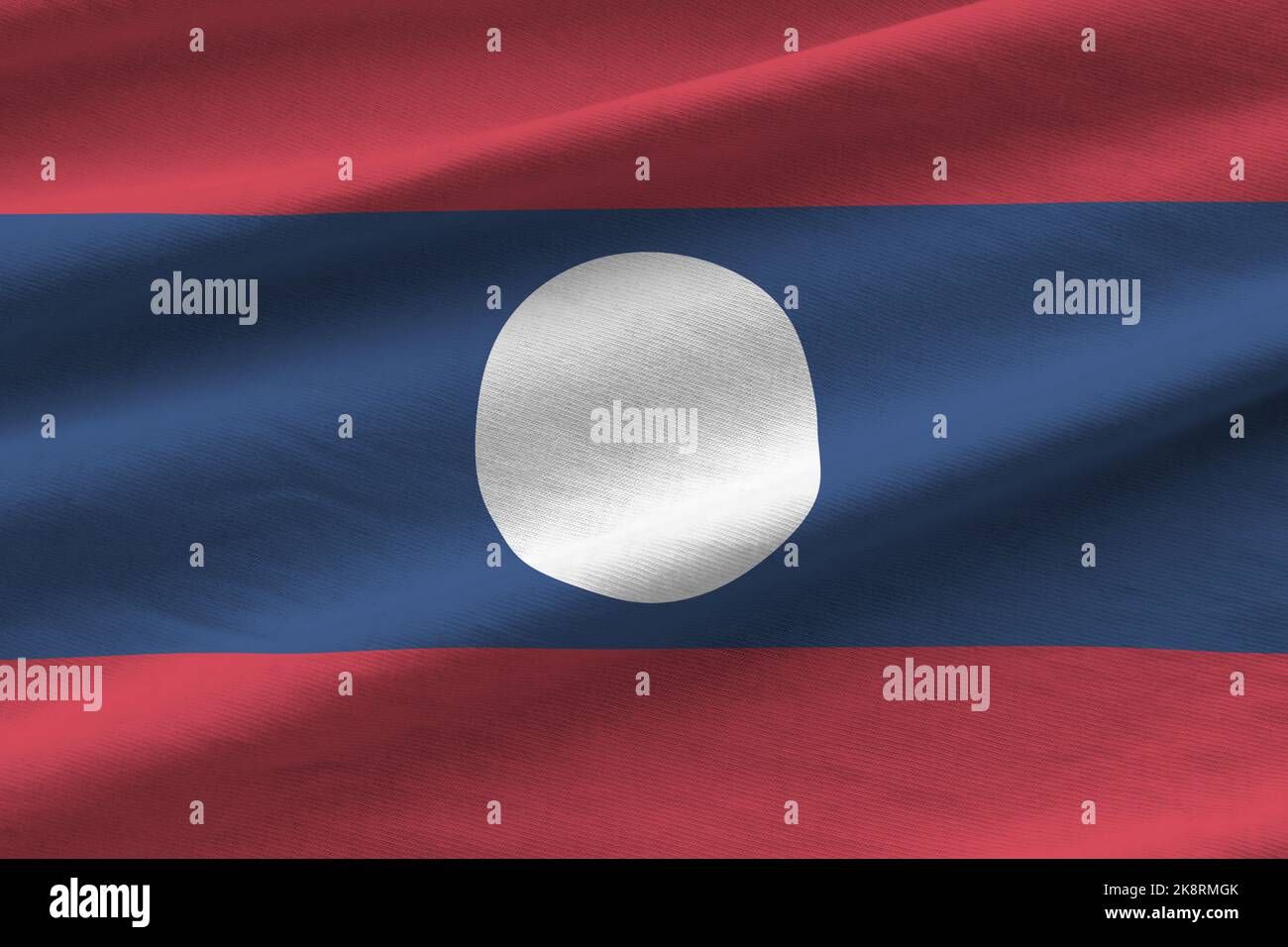 Laos flag with big folds waving close up under the studio light indoors ...