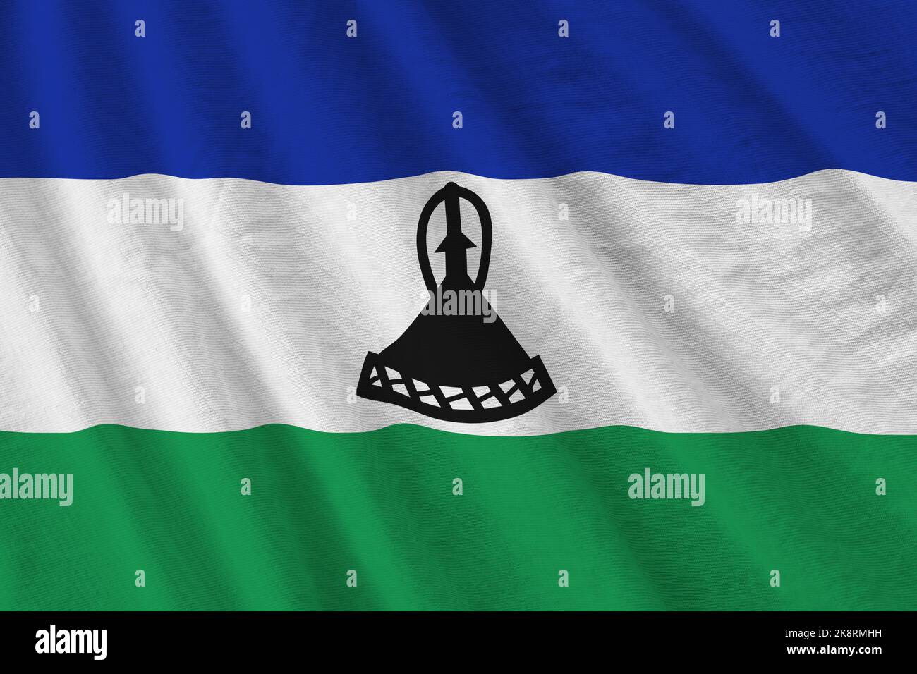 Lesotho flag with big folds waving close up under the studio light ...