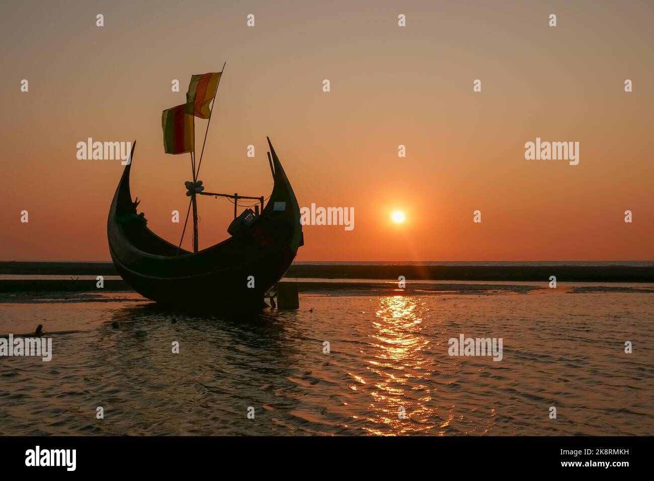Sunset landscape view of traditional wooden fishing boat known as moon ...