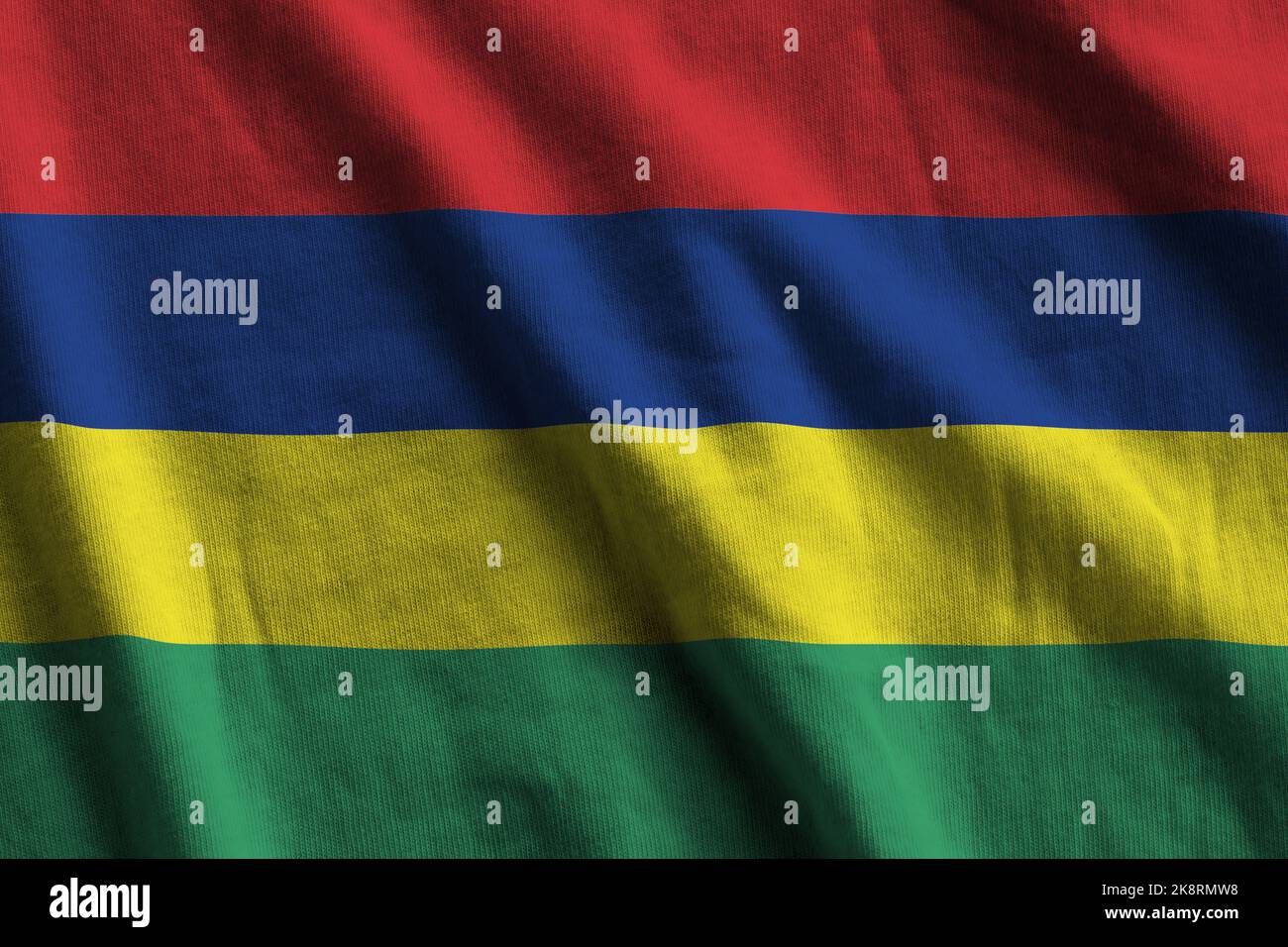 Mauritius flag with big folds waving close up under the studio light ...