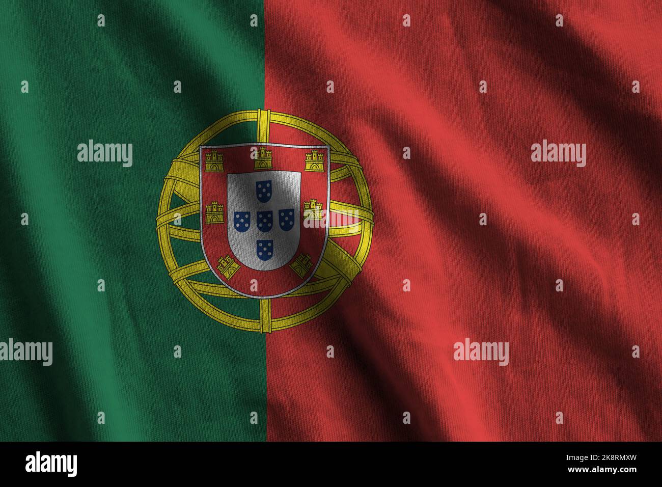Portugal flag with big folds waving close up under the studio light ...