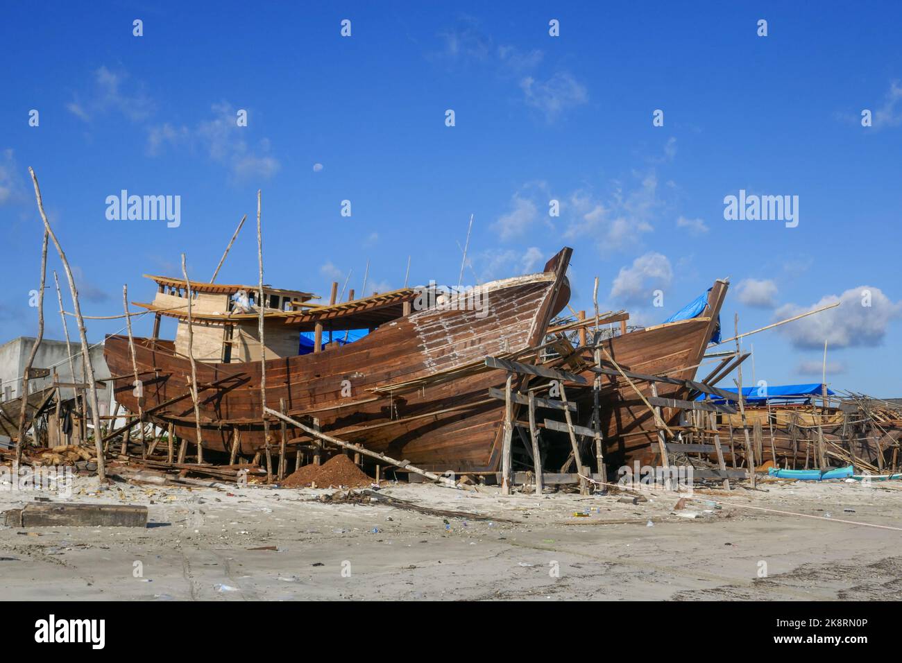 Landscape view of Bugis traditional shipyard with wooden phinisi boats ...