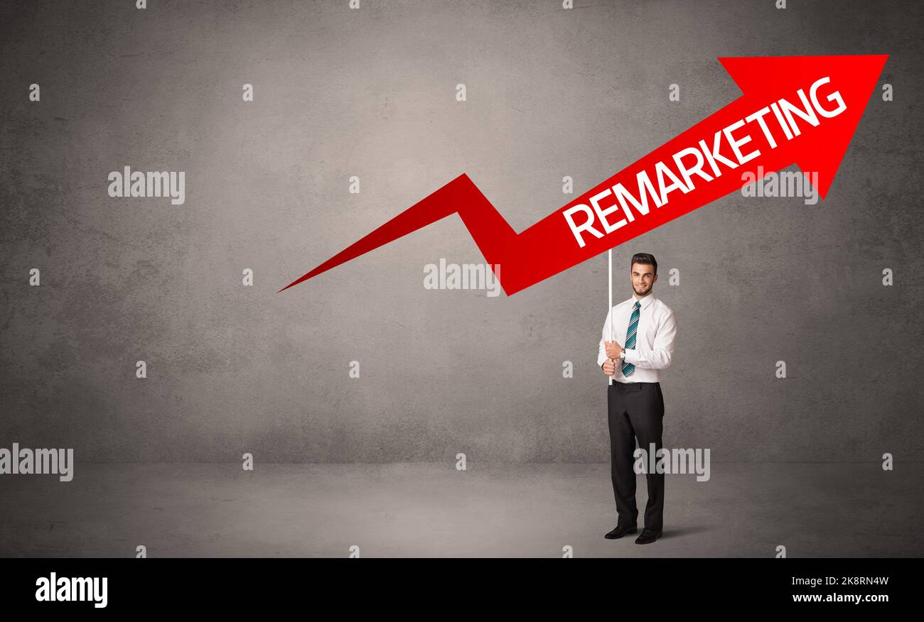 Young business person in casual holding road sign Stock Photo - Alamy