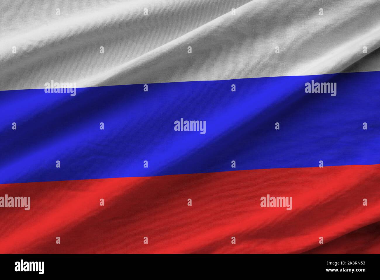 Russia flag with big folds waving close up under the studio light ...