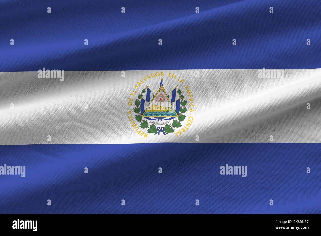 El Salvador flag with big folds waving close up under the studio light ...