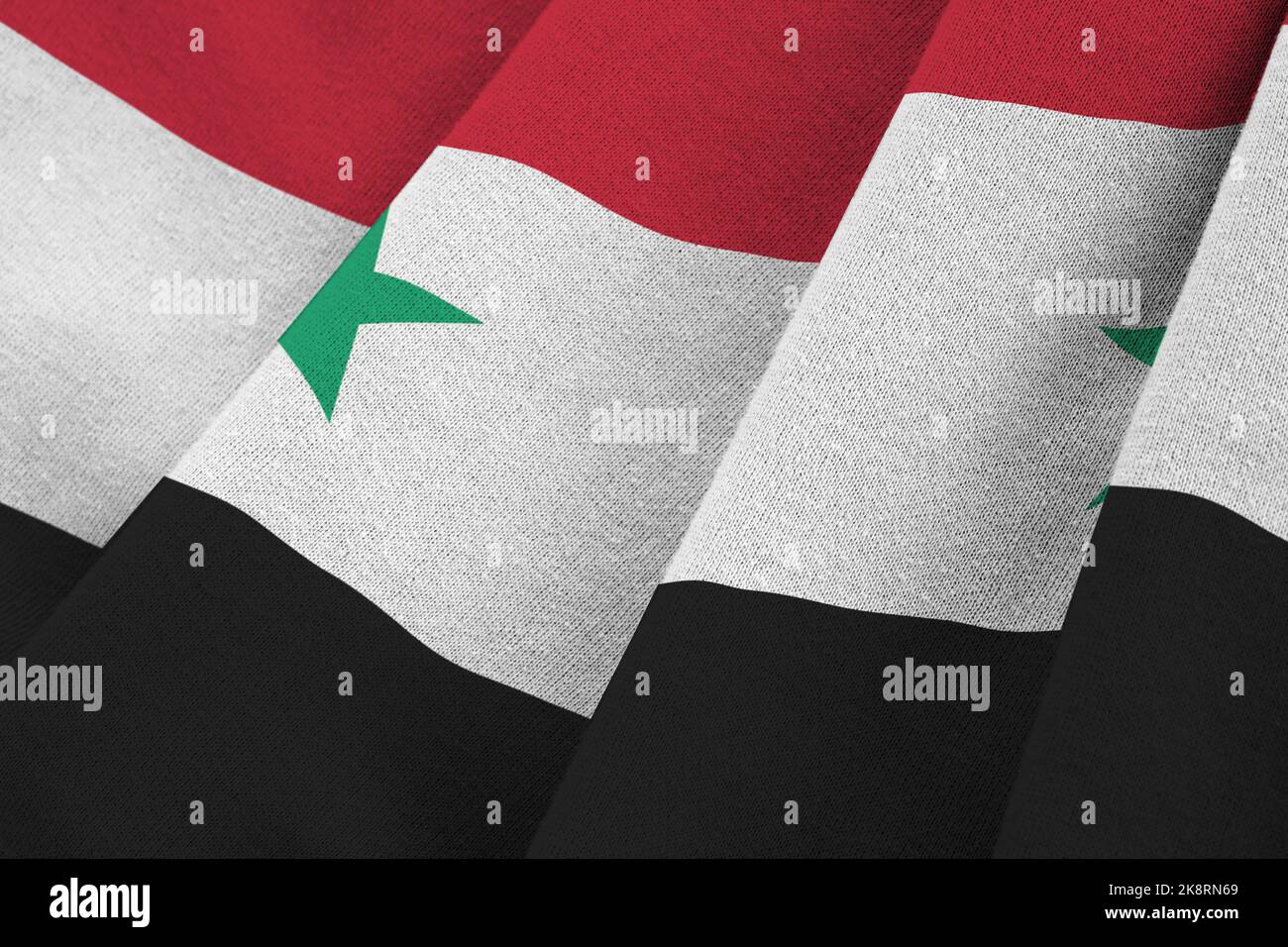 Syria flag with big folds waving close up under the studio light ...