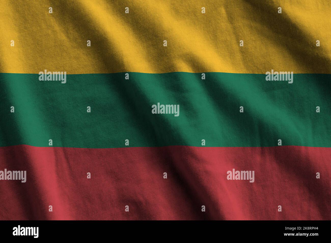 Lithuania flag with big folds waving close up under the studio light ...