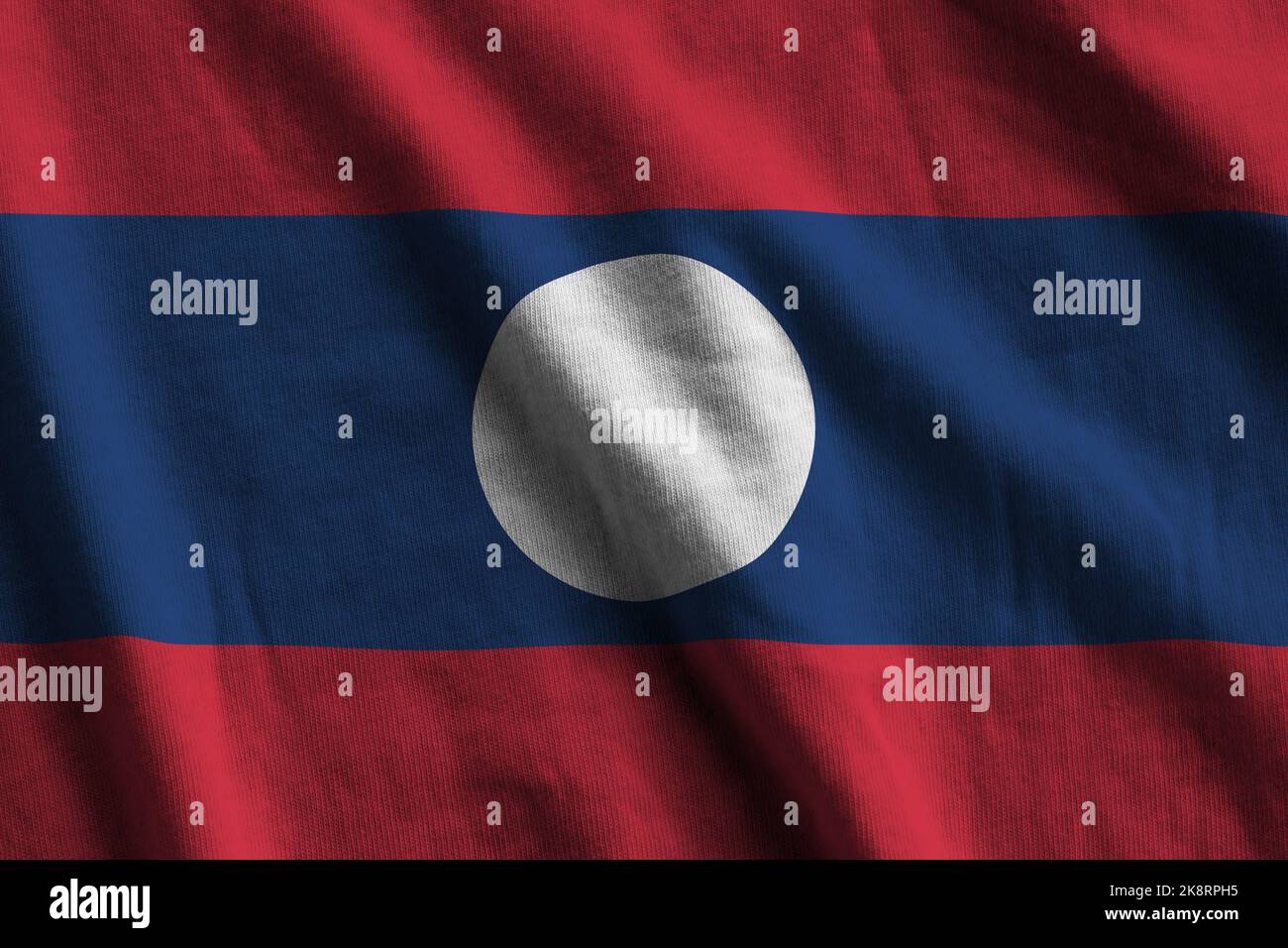 Laos flag with big folds waving close up under the studio light indoors ...
