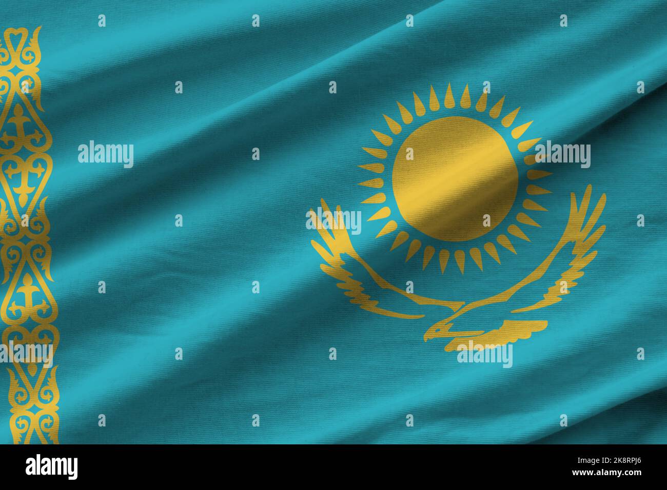 Kazakhstan flag with big folds waving close up under the studio light ...