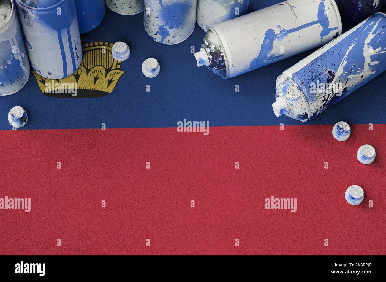Liechtenstein flag and few used aerosol spray cans for graffiti ...