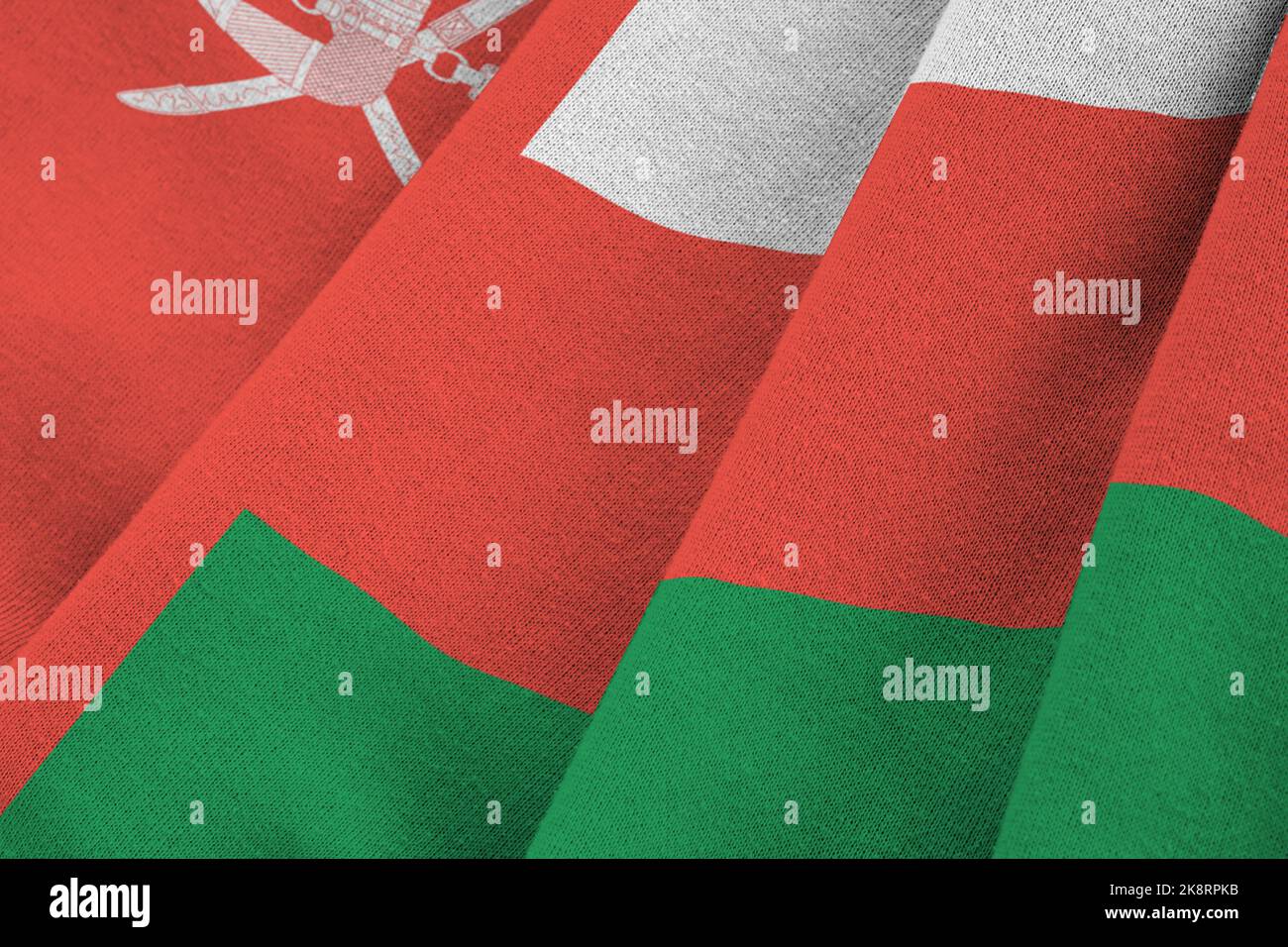 Oman flag with big folds waving close up under the studio light indoors ...