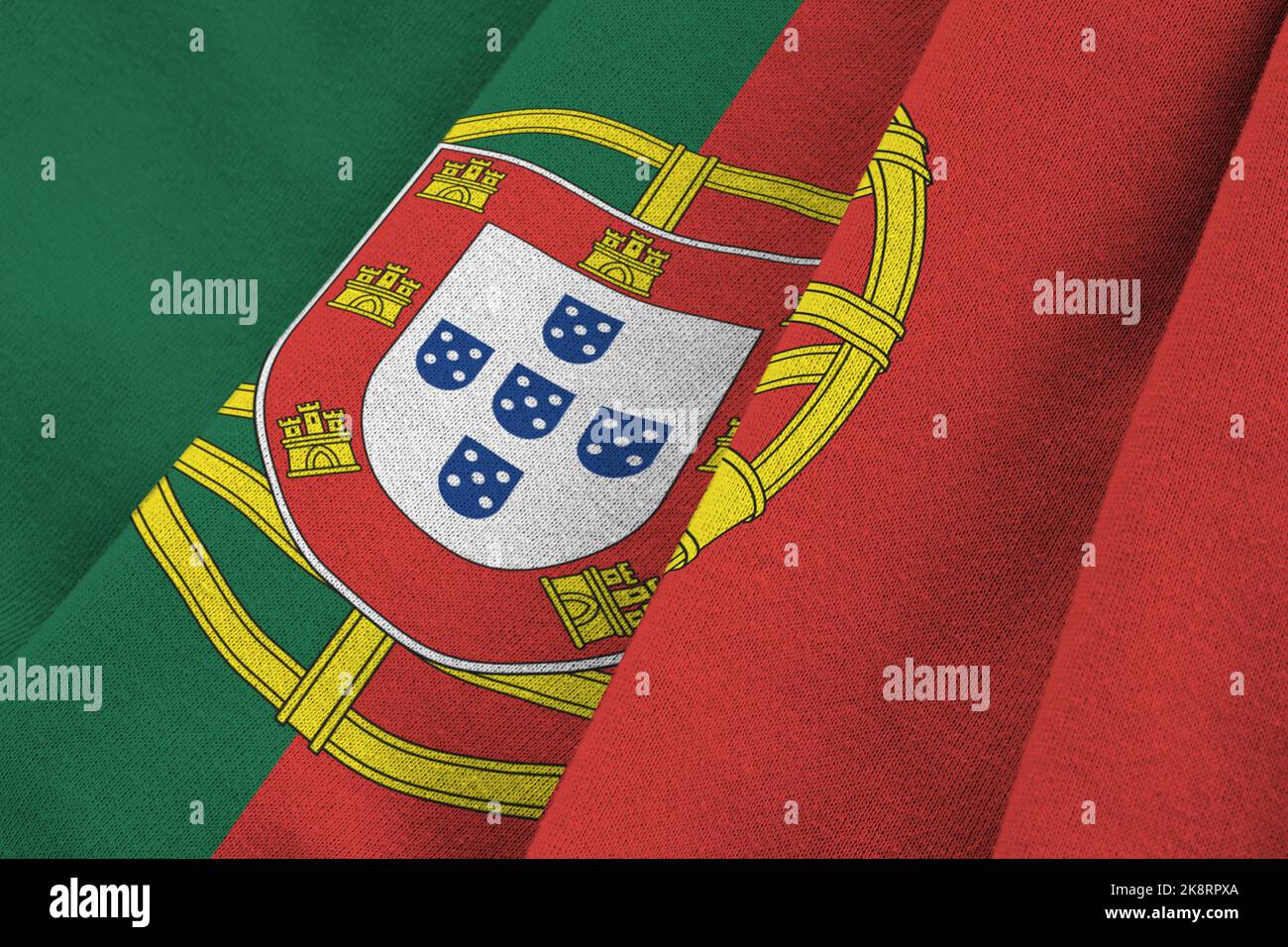 Portugal flag with big folds waving close up under the studio light ...