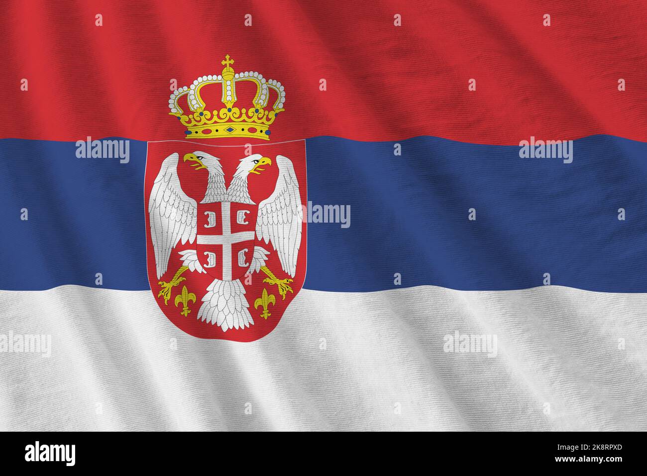 Serbia flag with big folds waving close up under the studio light ...
