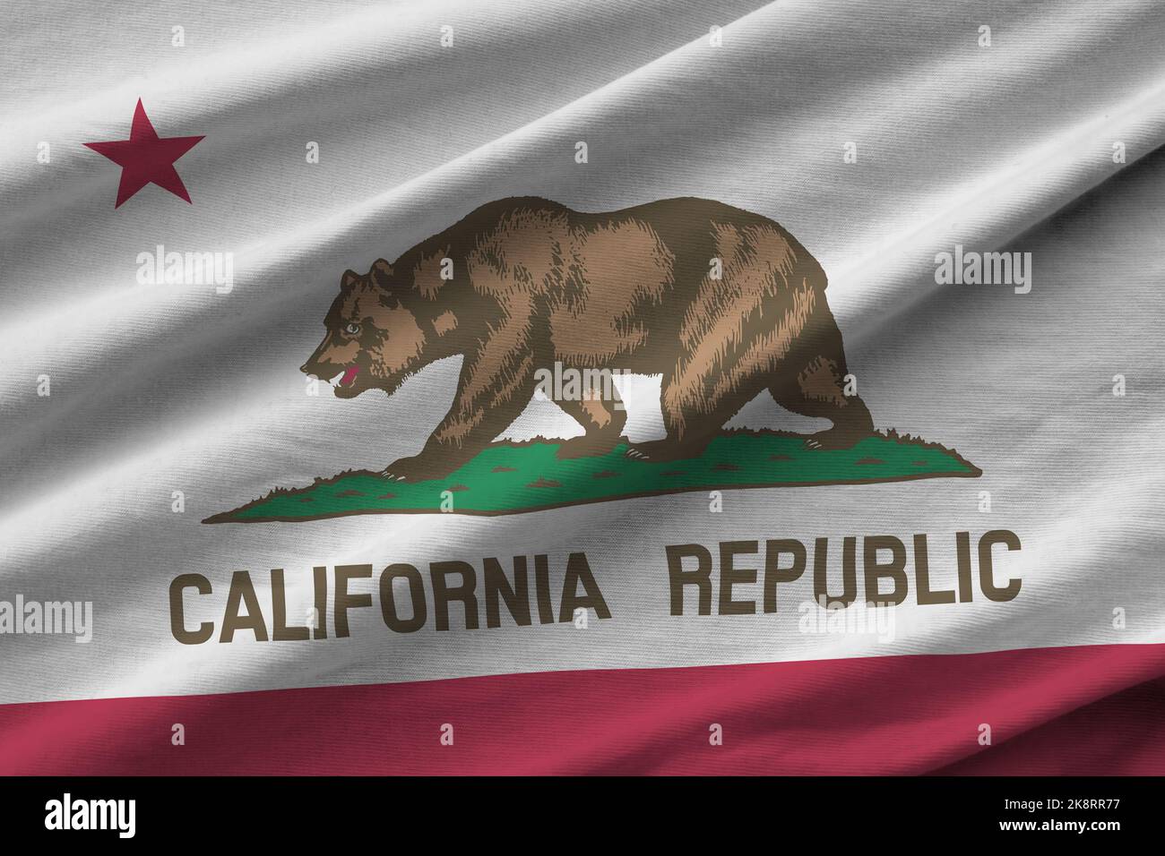 California US state flag with big folds waving close up under the ...