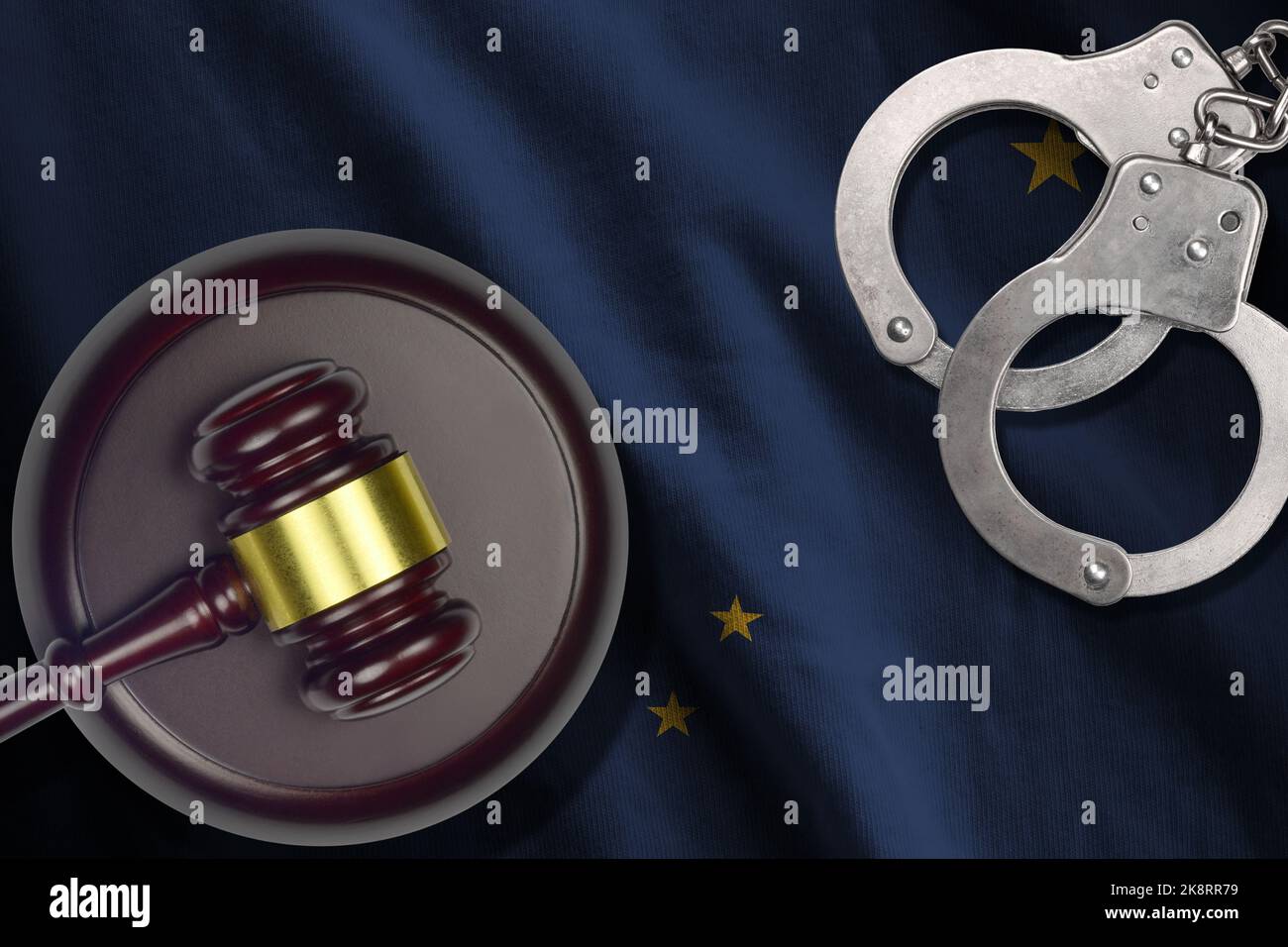 Alaska US state flag with judge mallet and handcuffs in dark room ...