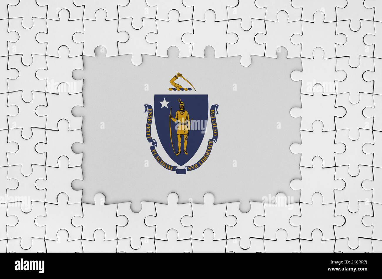 Massachusetts US state flag in frame of white puzzle pieces with ...