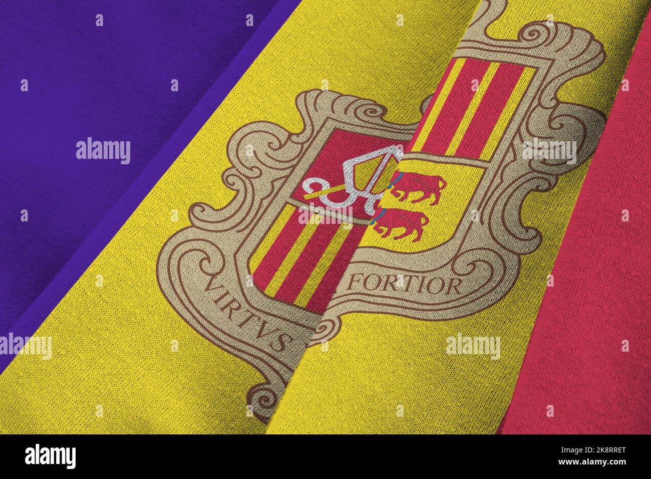 Andorra flag with big folds waving close up under the studio light ...