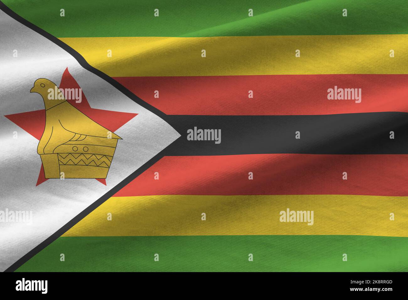Zimbabwe flag with big folds waving close up under the studio light ...