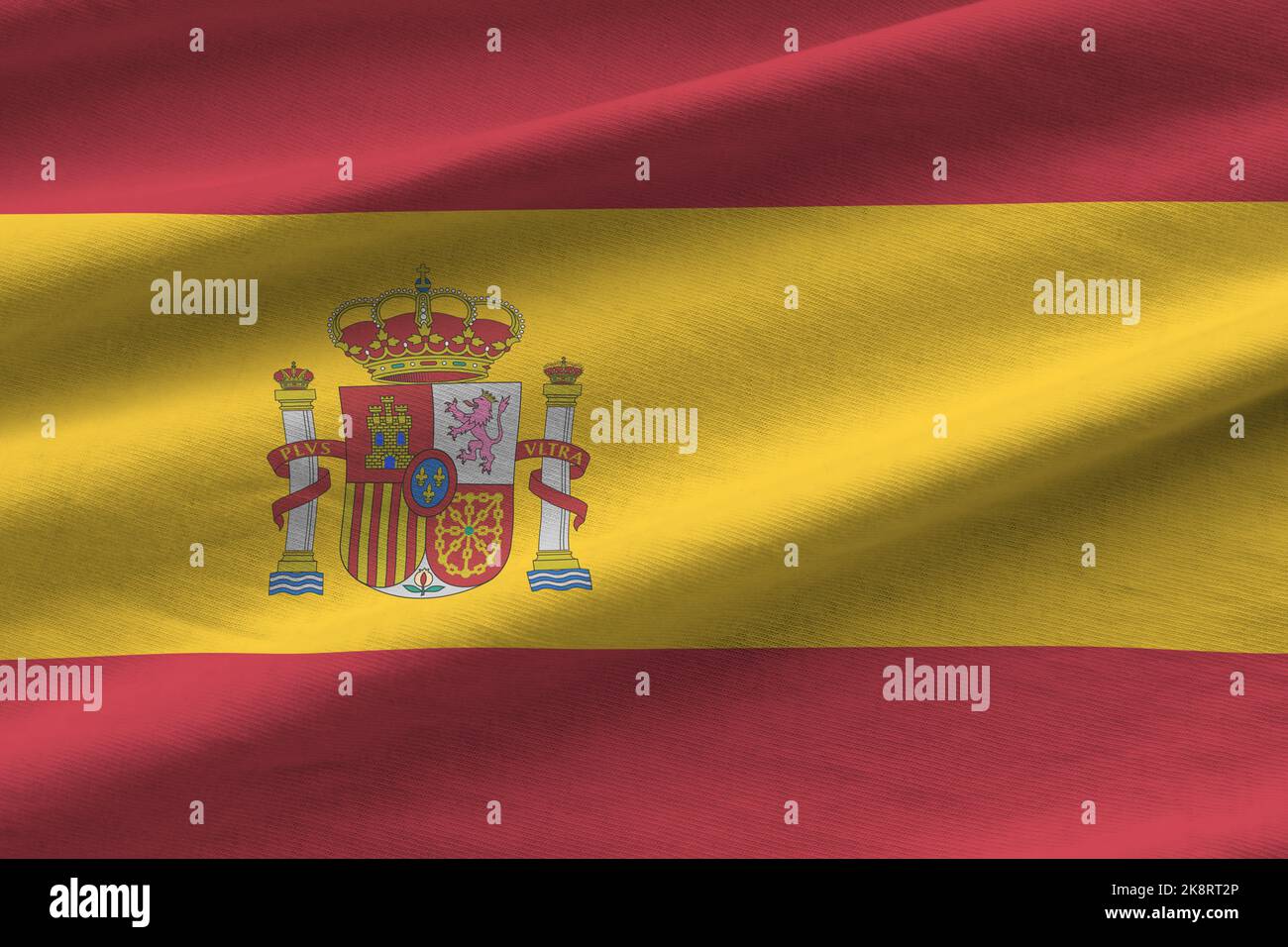 Spain flag with big folds waving close up under the studio light indoors. The official symbols ...