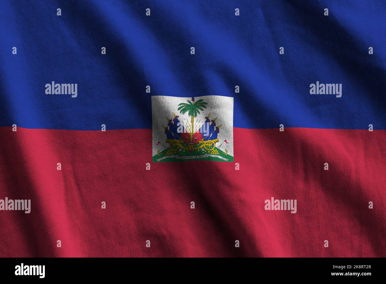 Haiti flag with big folds waving close up under the studio light ...