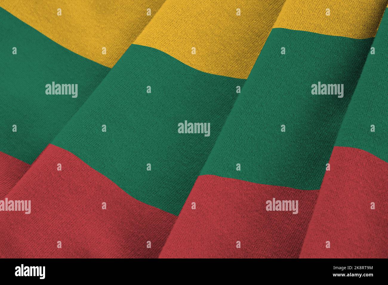 Lithuania flag with big folds waving close up under the studio light ...