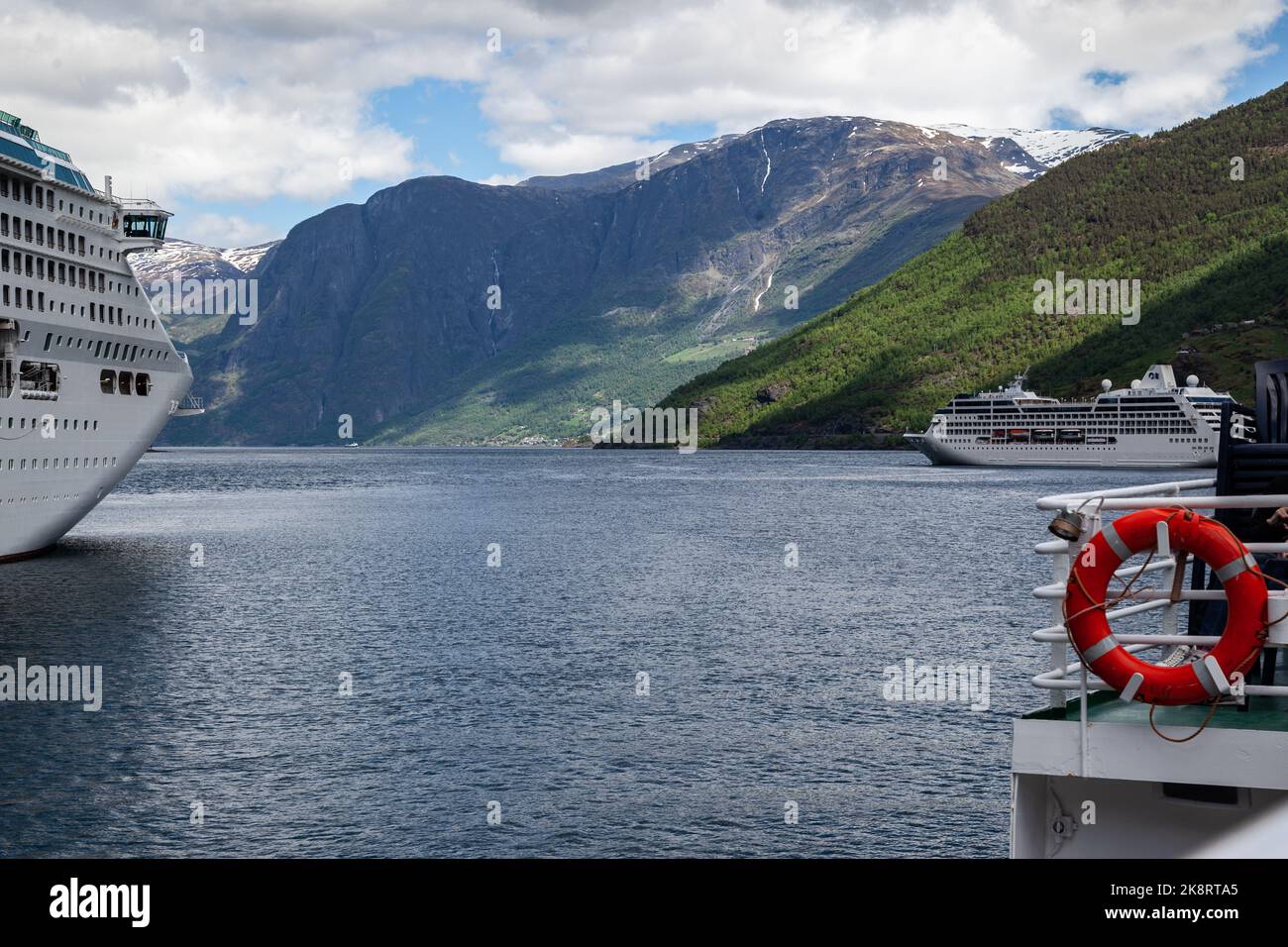 arge white ships sailing between the rocky mountains in Narrow fjord ...