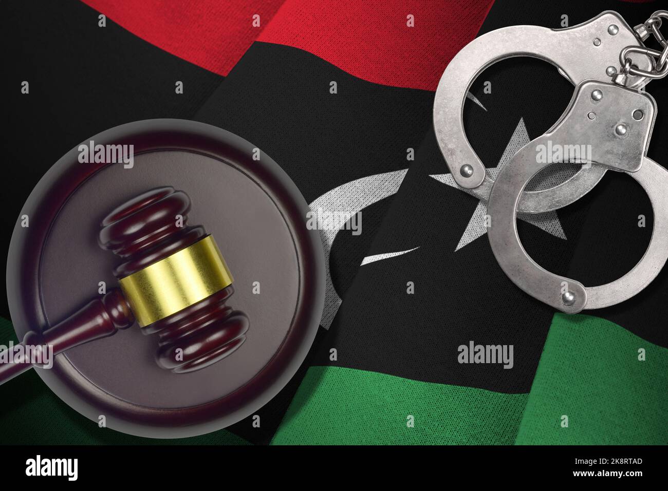 Libya flag with judge mallet and handcuffs in dark room. Concept of ...