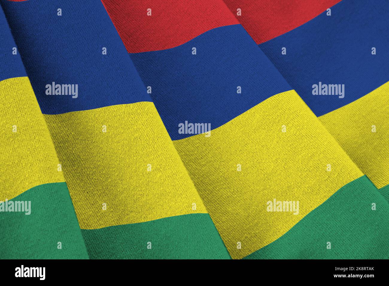 Mauritius flag with big folds waving close up under the studio light ...