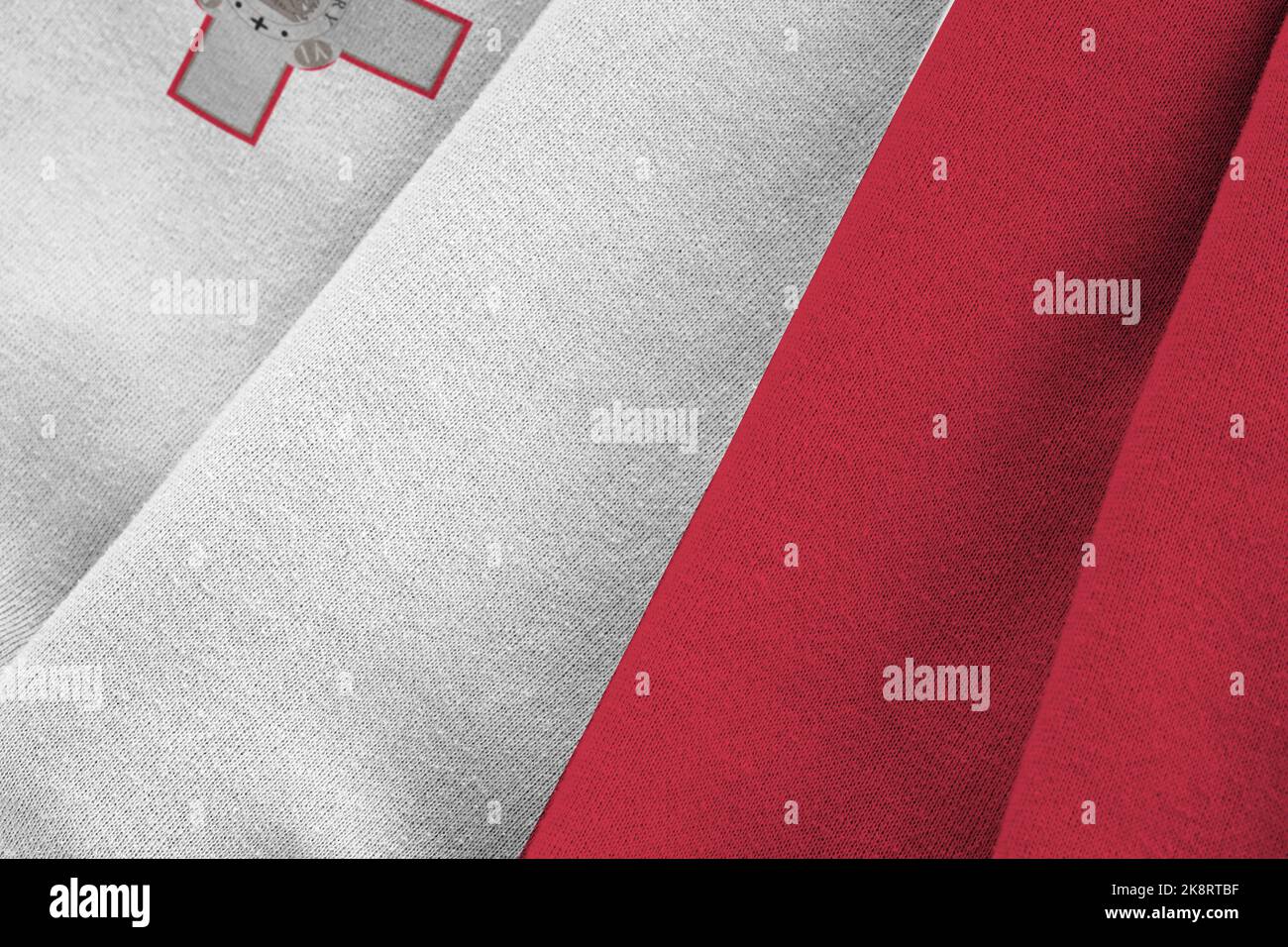 Malta flag with big folds waving close up under the studio light ...