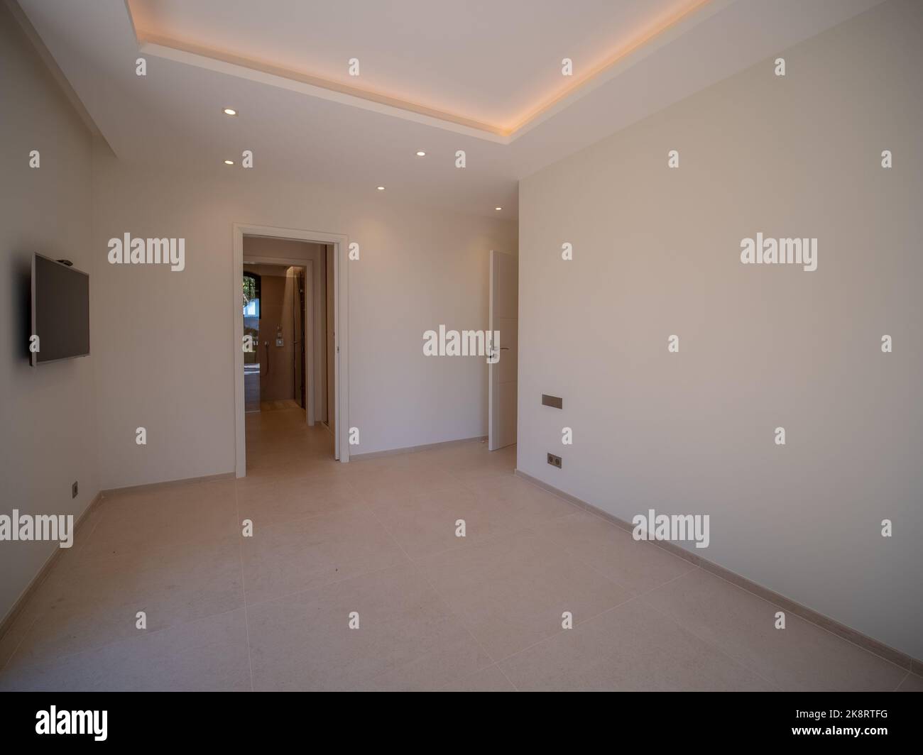 A large modern room with a corridor and a shower in the back Stock ...