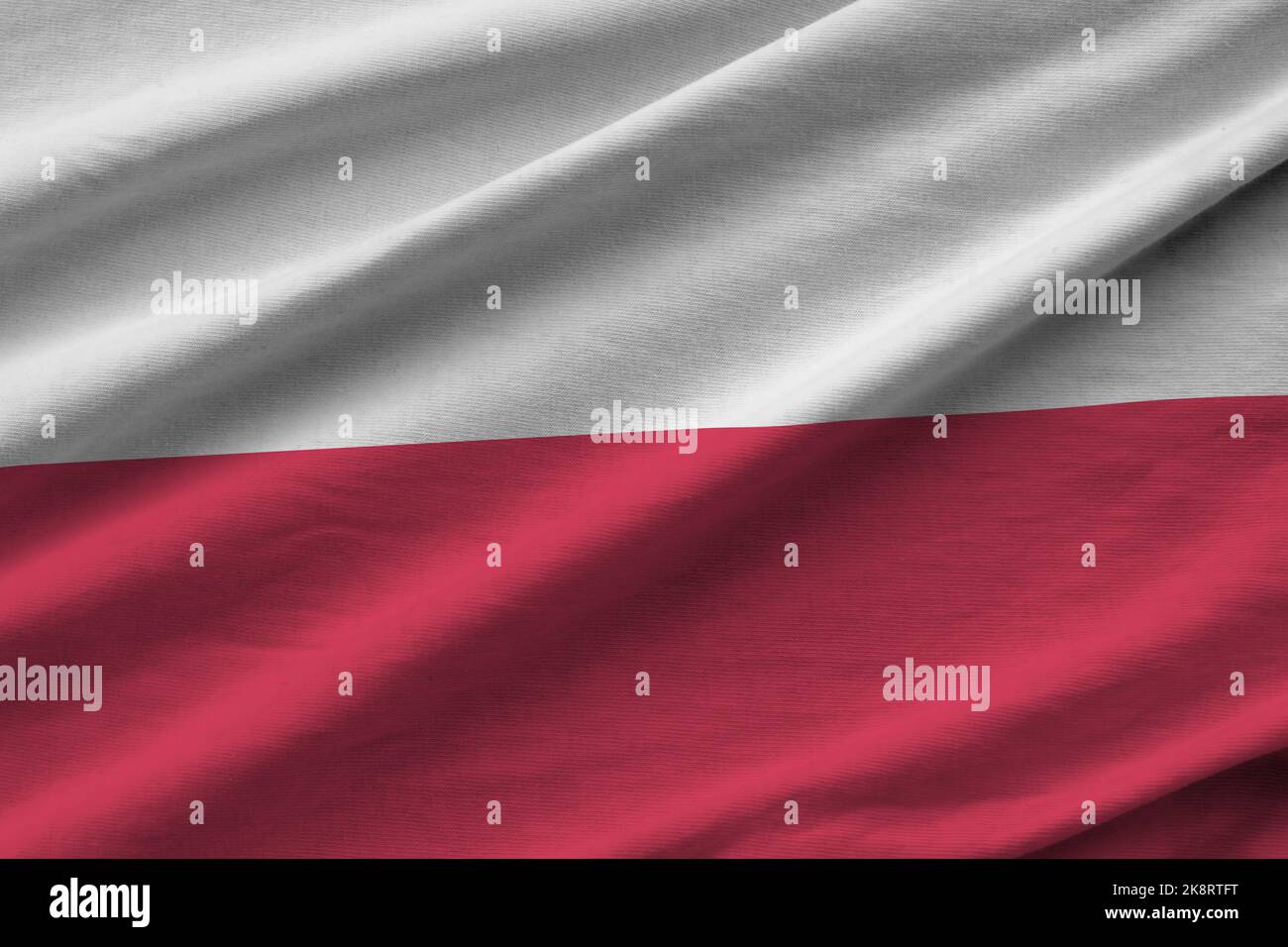 Poland flag with big folds waving close up under the studio light ...