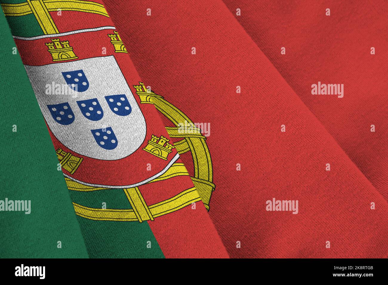 Portugal flag with big folds waving close up under the studio light ...